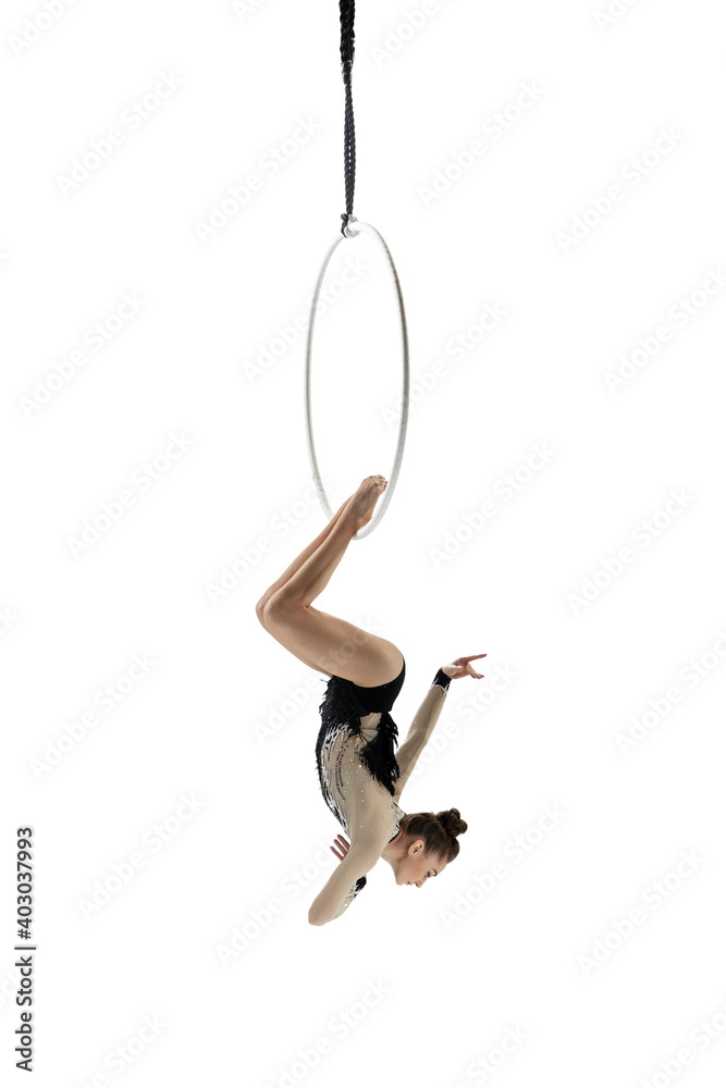 Dangerous. Young female acrobat, circus athlete isolated on white ...