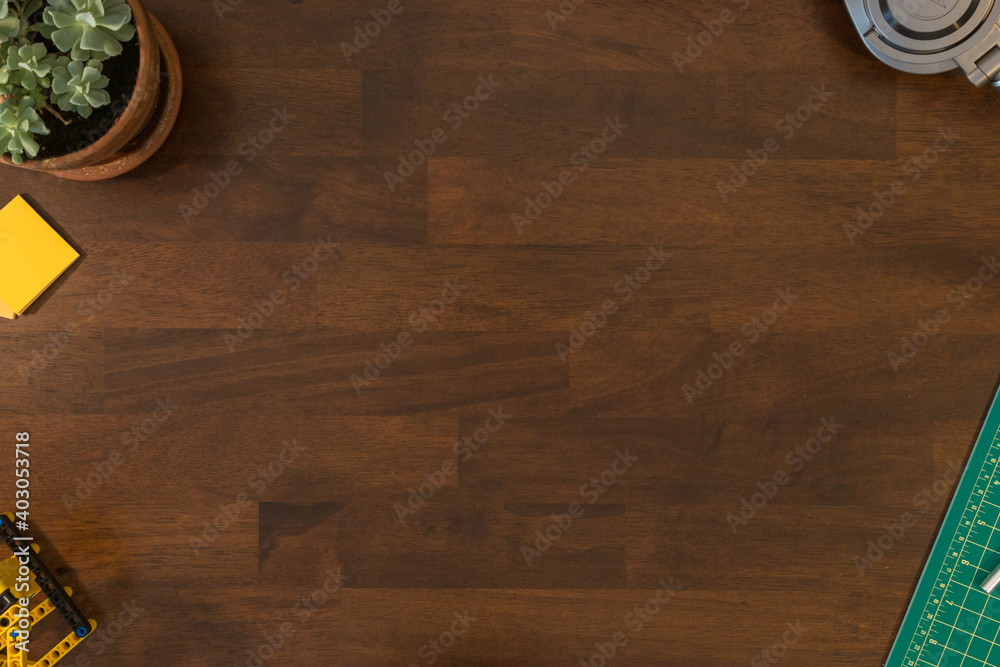 Overhead view of a home wooden office table and studio desk with ...