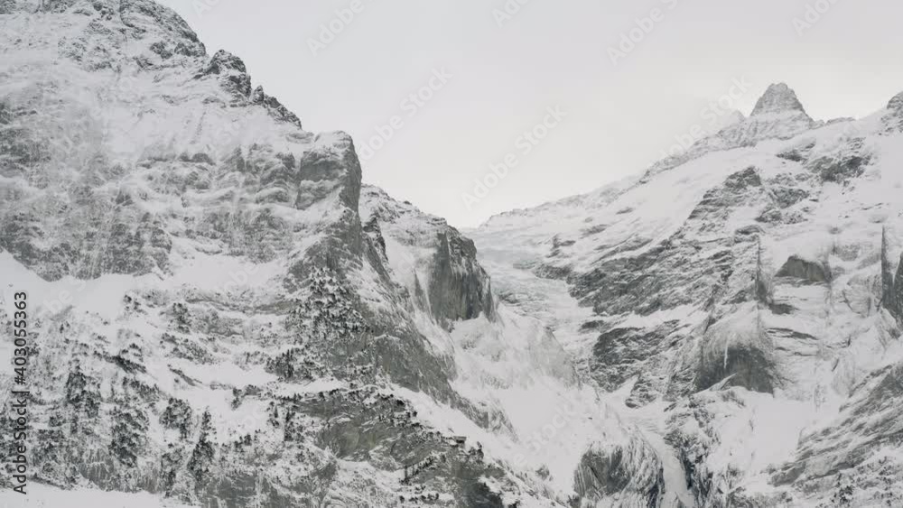 Drone Aerial view of the snowy Grindelwald and the Eiger in the ...
