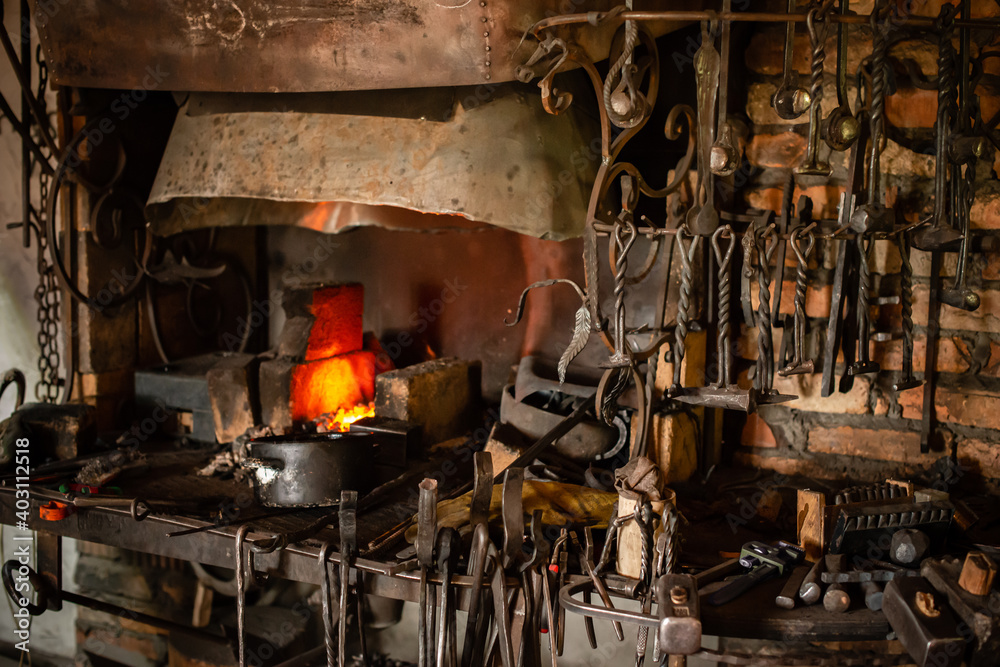 Interior of Blacksmith forge with tools hanging on wall and anvil and ...