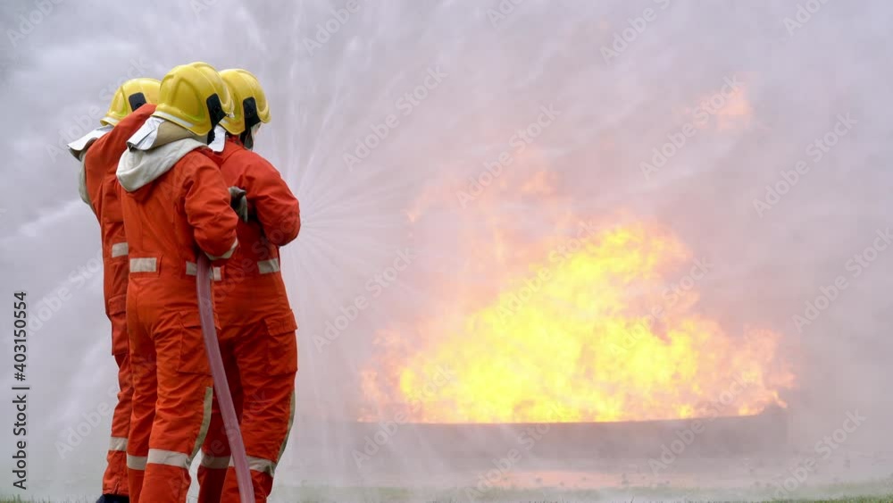 Firefighter teamwork in fire protection suit on safety rescue duty ...