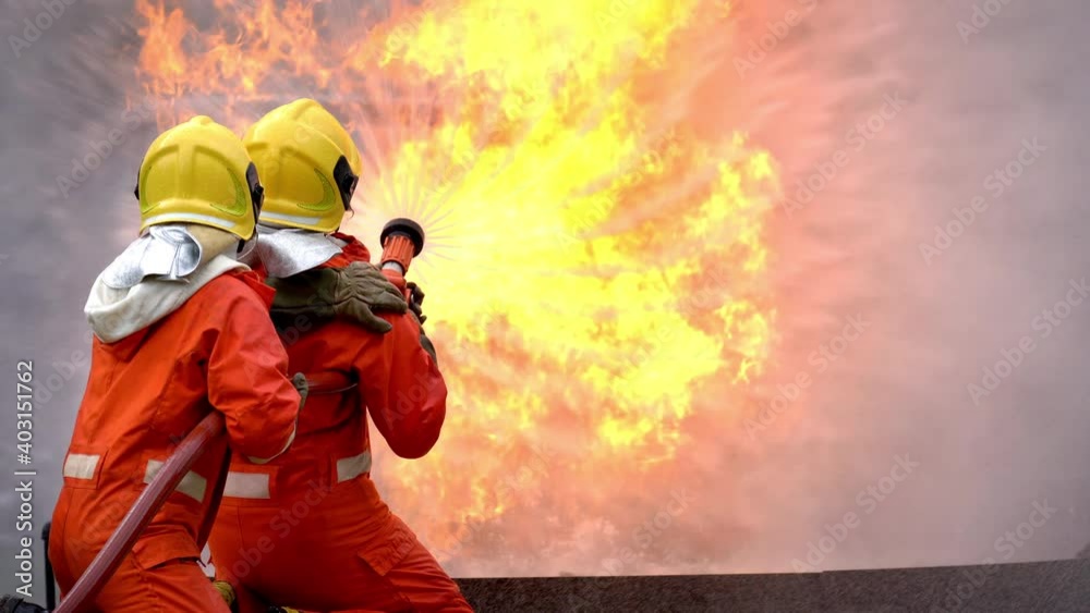 Firefighter teamwork in fire protection suit on safety rescue duty ...