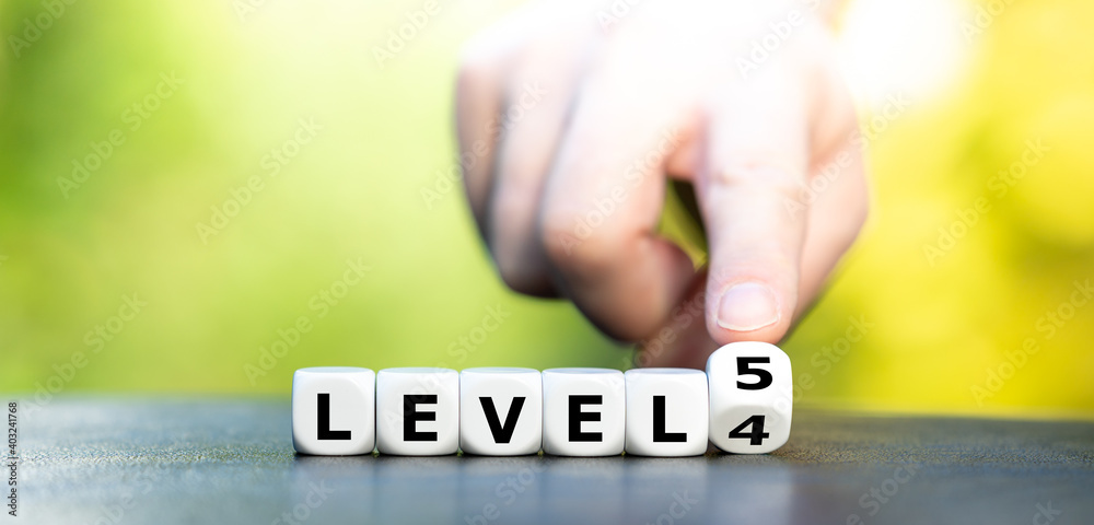 Hand turns dice and changes the expression "level 4" to "level 5 ...