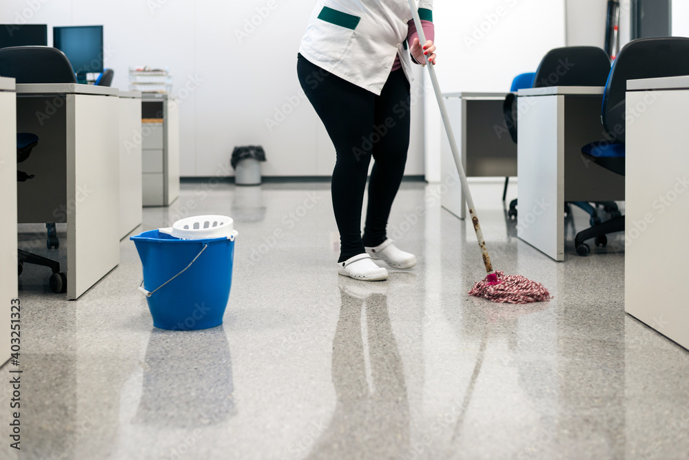 Woman cleaning school classroom with bucket and mop. Disinfection of ...