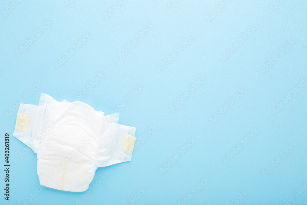 White soft new baby diaper on light blue table background. Pastel color ...