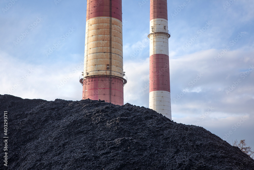 Coal heap, natural black coal with industrial chimneys. Industrial ...