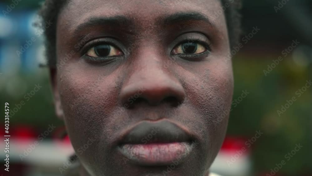 Close up face portrait. The African looks straight into the camera ...