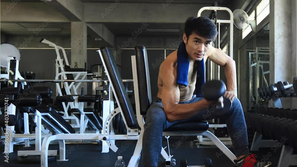 Asian shirtless sporty muscular bodybuilder man stretching exercise ...