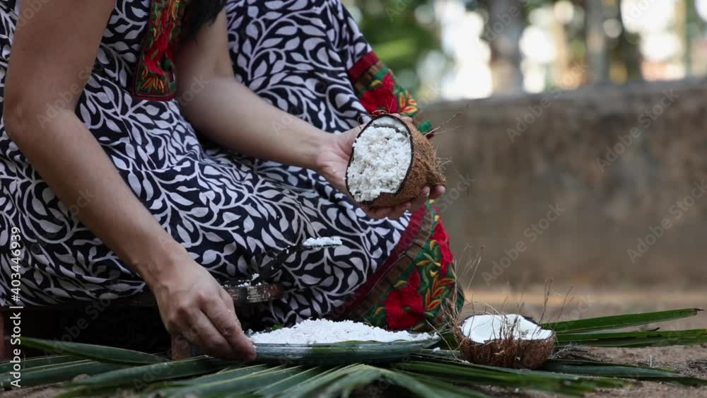 Woman hand grating fresh raw coconut cut open in half 4K slow motion ...