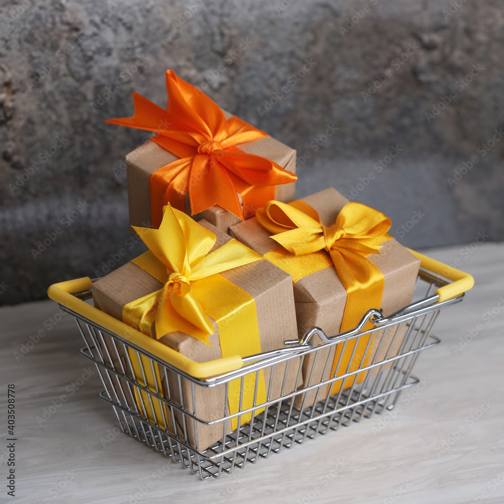 Two gift boxes wrapped by kraft brown paper with beautiful yellow satin ...