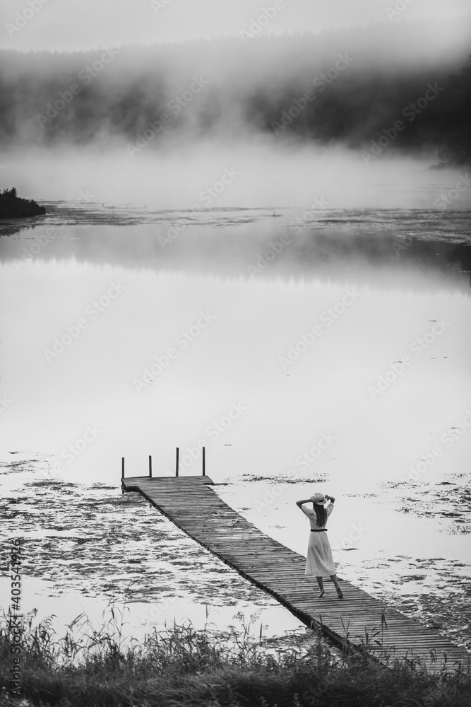 Black and white monochrome picture of young woman in white dress ...