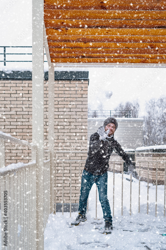 Snow battle. A middle aged man throwing a snowball. Dad and son playing ...