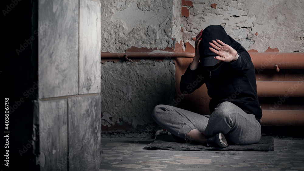 The concept of drug addiction and homelessness. A depressed and ...