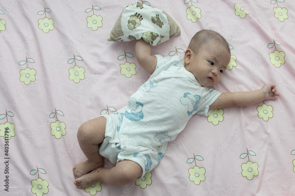 Happy Smiling face Asian Chinese baby boy during lying on bed. Happy ...