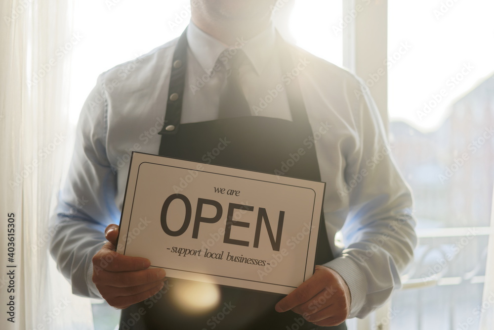 Small Business Owner holding sign for restaurant during lockdown ...