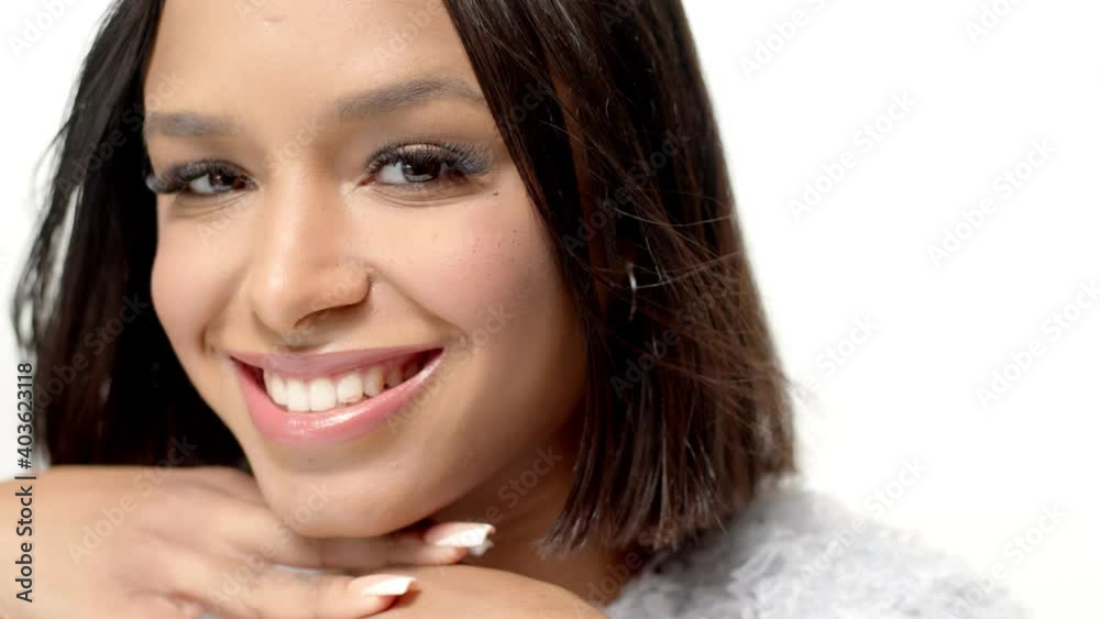 Dark Skin Girl Posing With Her Hands Under The Chin Looking In The Camera Smiling Hair Blown