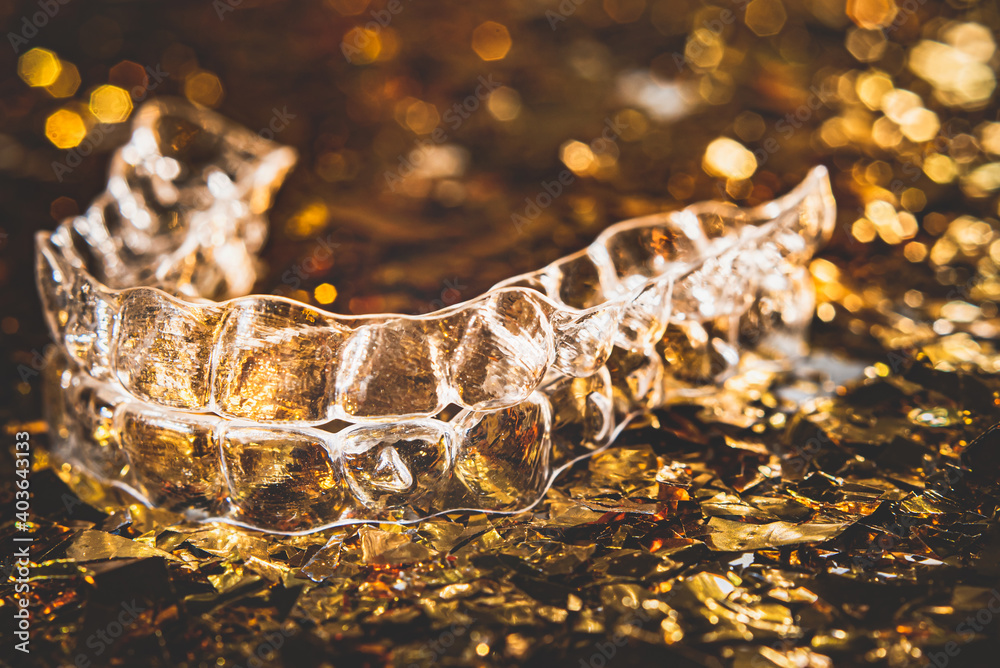 Invisible dental teeth brackets tooth aligners on gold background ...