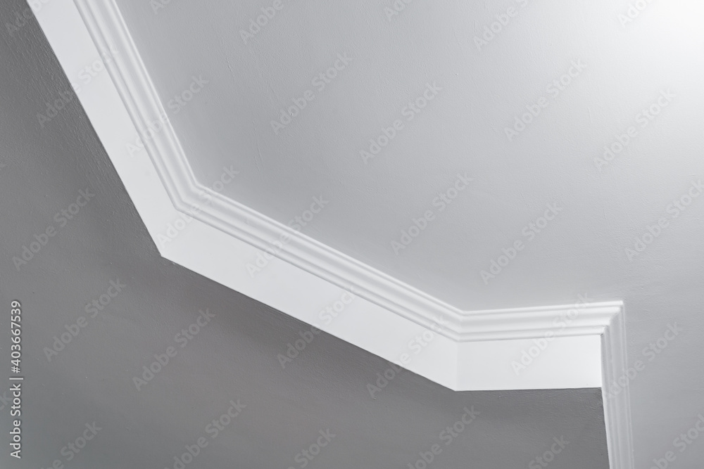 Detail of corner ceiling with intricate crown molding. Suspended ...