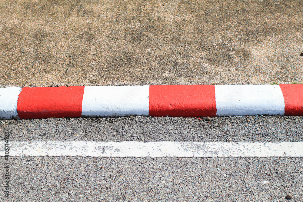 Red and white concrete sidewalk signs on a road. Footpath road. White ...