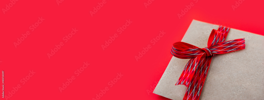 long format banner empty kraft envelope with red ribbon tied in bow on ...