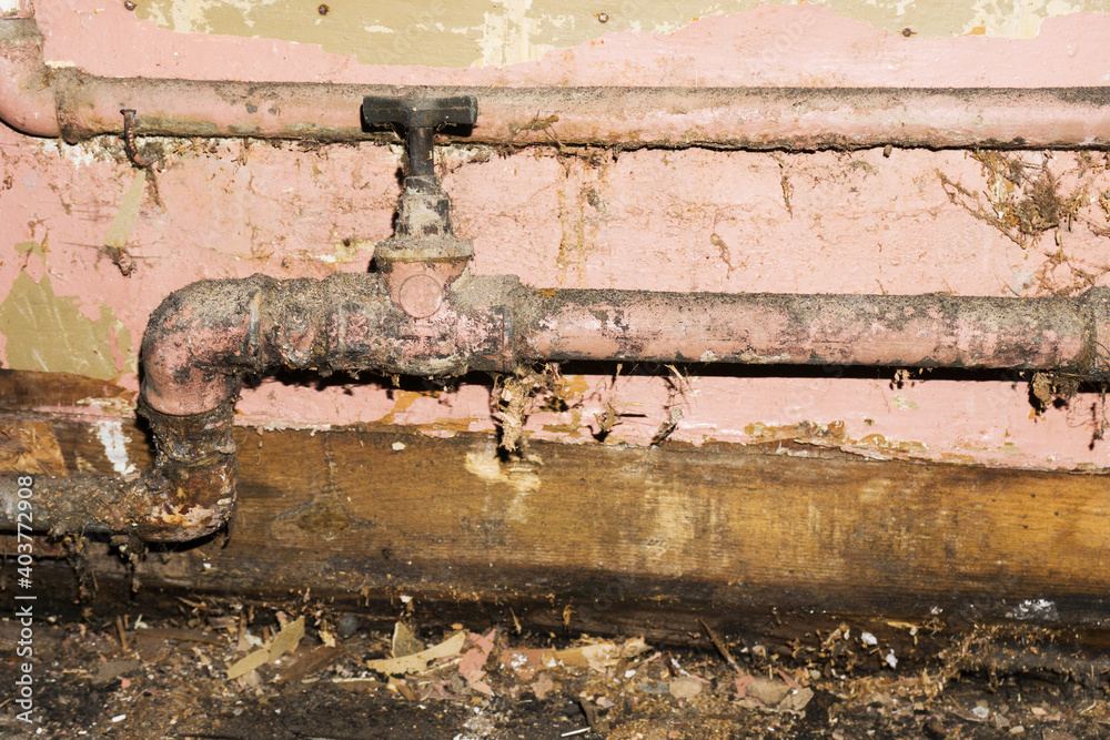 Dirty water pipe. Old pipeline construction. Rusty plumbing system ...