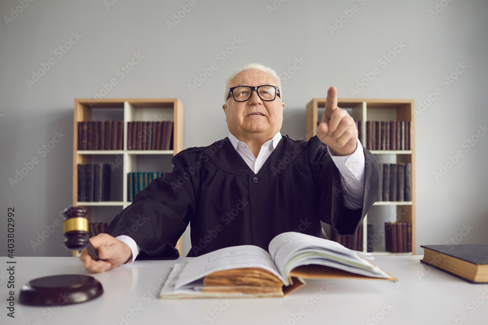 Strict judge finds the accused guilty, passes judgement and rules the ...