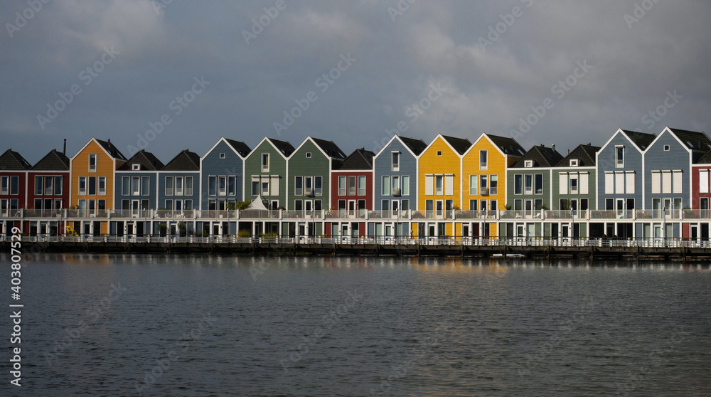 Colorful wooden rainbow houses modern architecture on Rietplas lake ...
