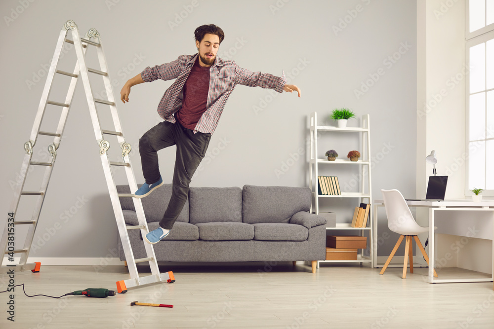 Foto de Unlucky young man has slipped from ladder while doing repairs ...