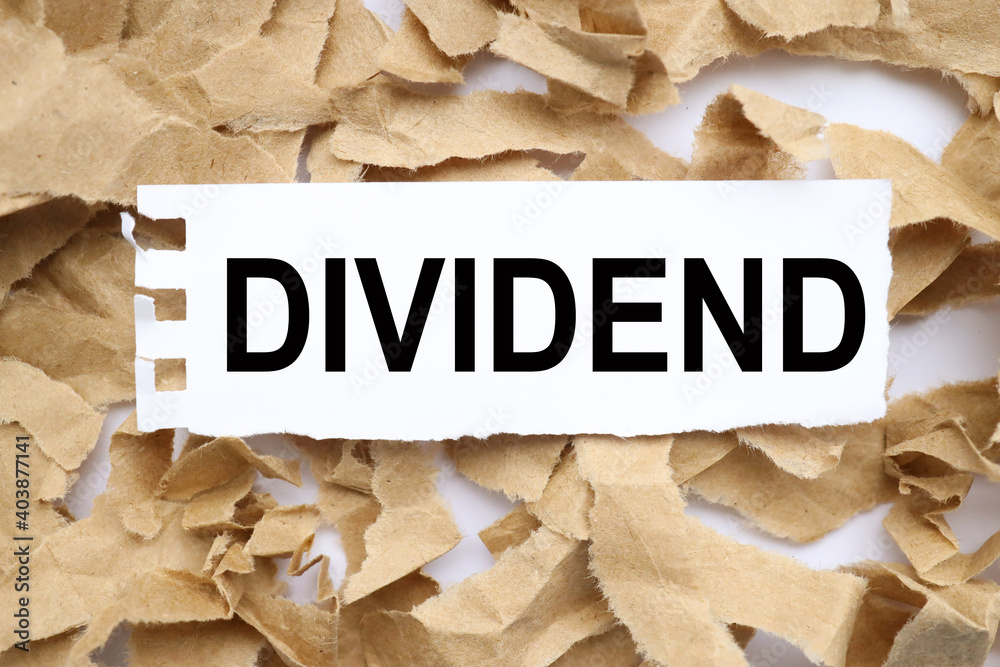 DIVIDEND, text on white paper on torn kraft paper background Stock ...