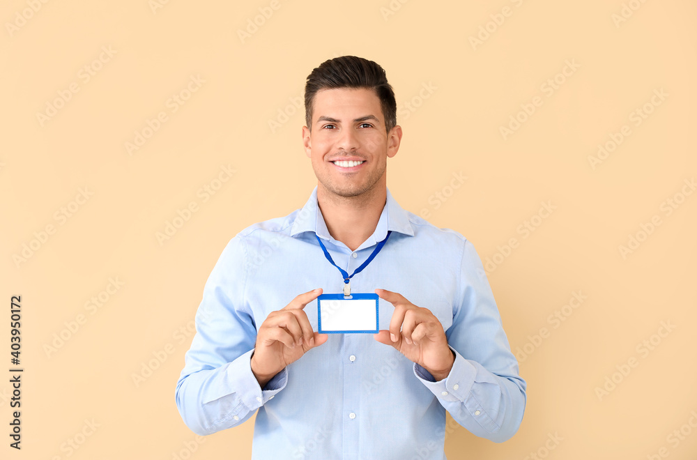 Young man with blank badge on color background Stock Photo | Adobe Stock