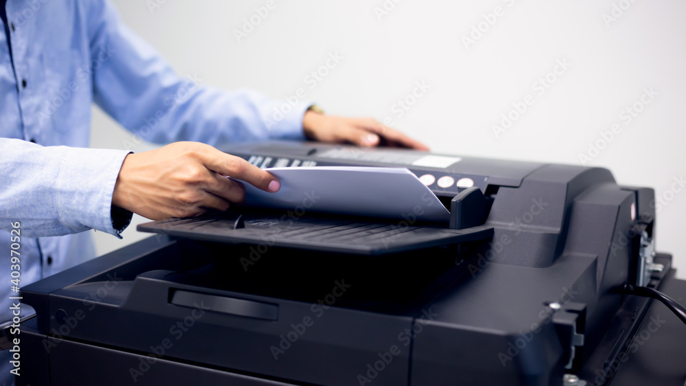 Bussiness man Hand press button on panel of printer, printer scanner ...