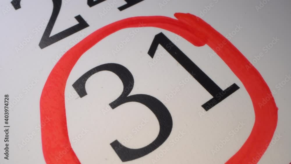31 - The hand circles the date in the calendar with a pen. Number in ...