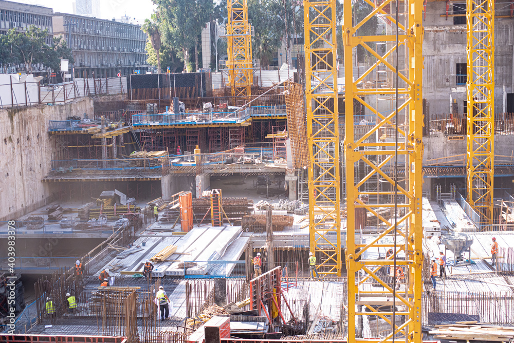 Construction site workers, top view on few level parking foundation ...