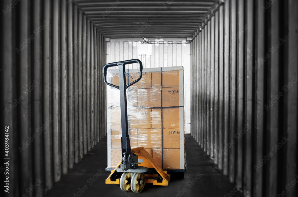 Inside view of shipping container. Package boxes stacked on pallet with ...