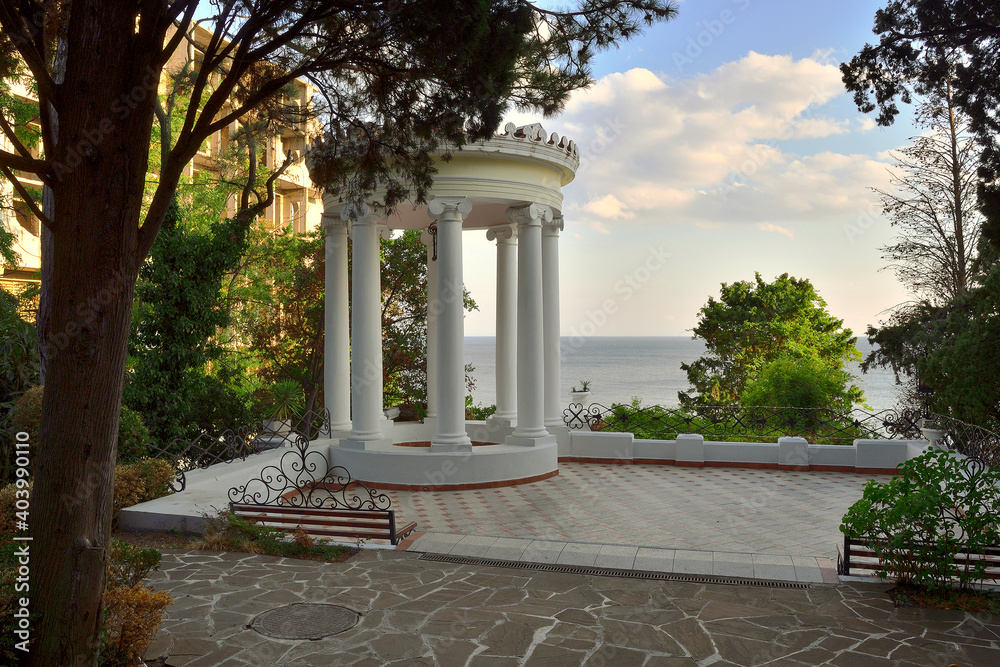 Round rotunda-gazebo with ionic columns in the garden on The black sea ...