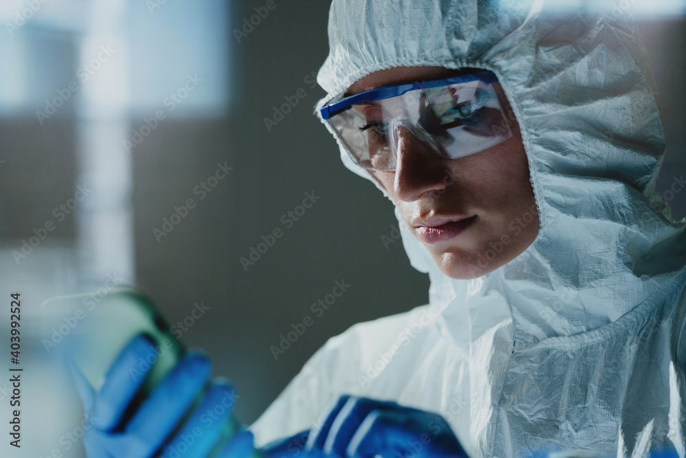 Vaccine researcher wearing personal protective equipment uses ...