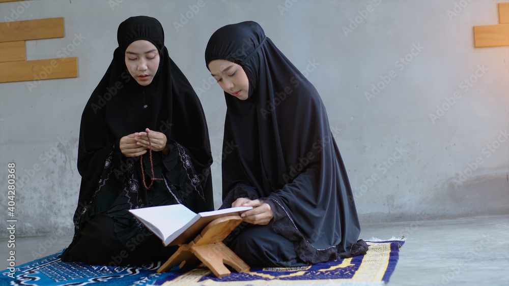 Portrait of an Asian muslim women in a daily prayer at home reciting ...