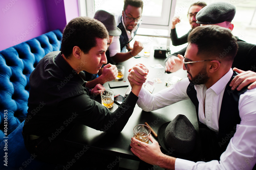Arm competition. Group of handsome retro well-dressed man gangsters ...