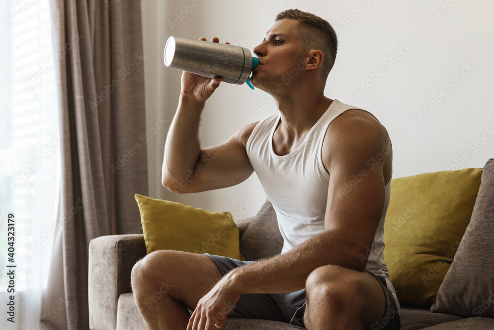 Man drinking protein shake after home workout Stock Photo | Adobe Stock