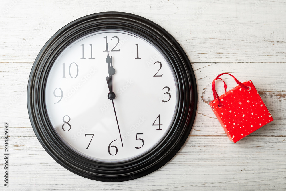 Time to give gifts concept. A clock showing a minute to twelve and a ...