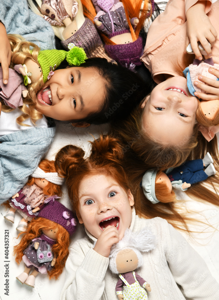 Children kids playing in kindergarten girls lying on a floor with ...