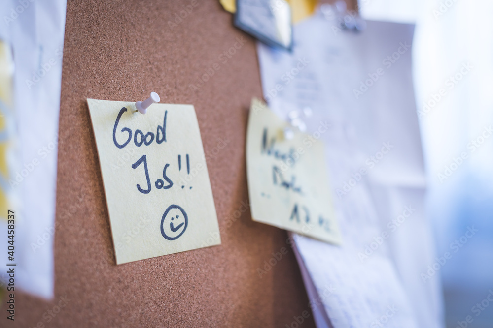 Employee motivation and leadership concept. “Good Job” note on pinned ...