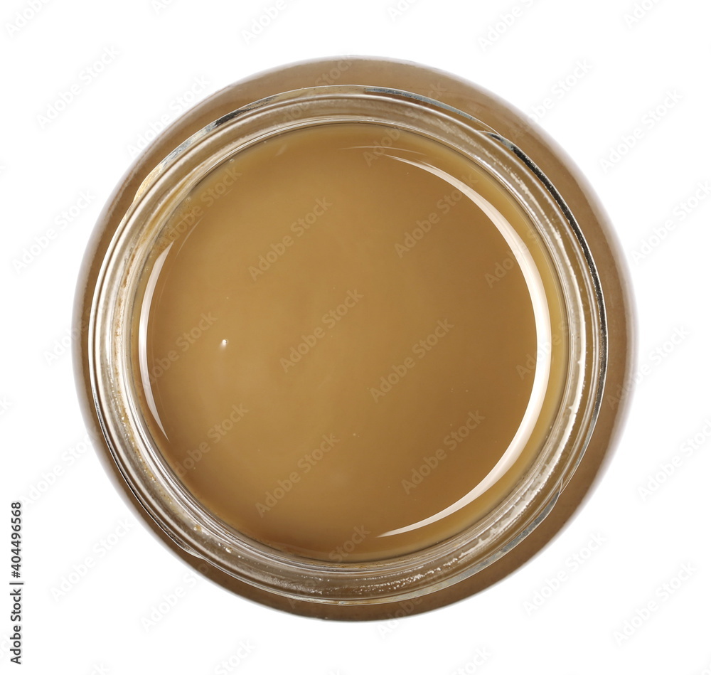 Integral sesame butter, unpeeled seeds, tahini paste in glass jar ...