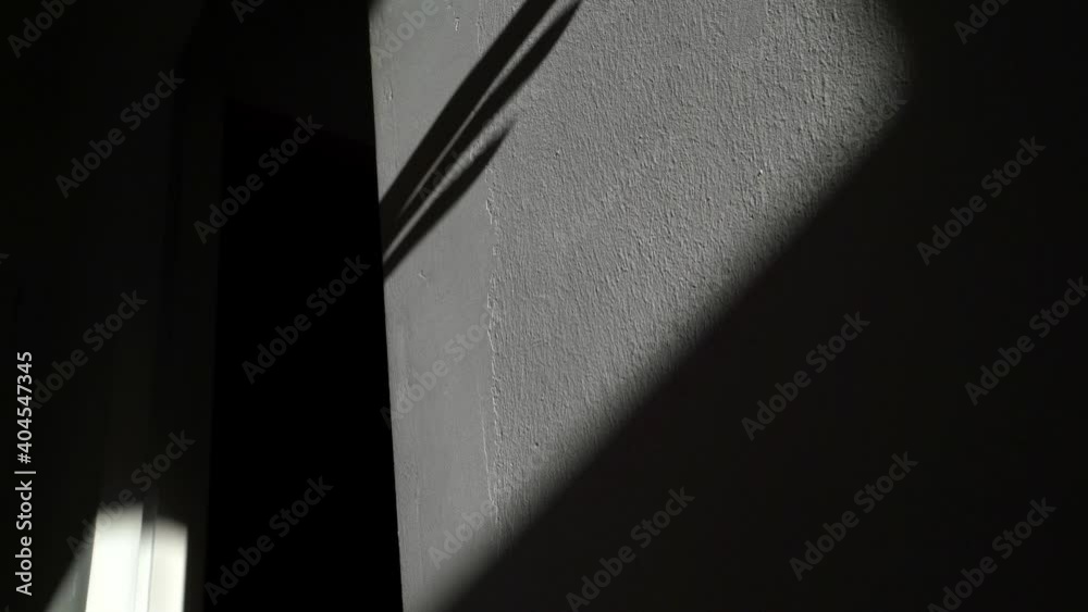 Scary shadow of the hand on the wall. The hand is crawling along the ...
