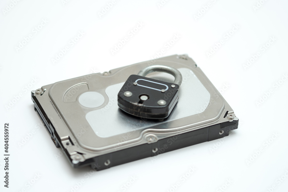 Computer hard disk and metal padlock symbolizing concept for encrypted ...