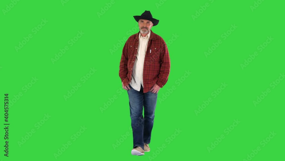 Adult smiling man in black cowboy hat walking on a Green Screen, Chroma ...