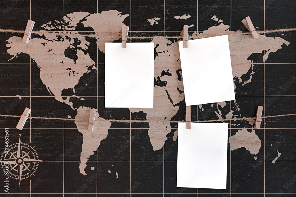Mockup of the world map with three white blank paper on a rope ...