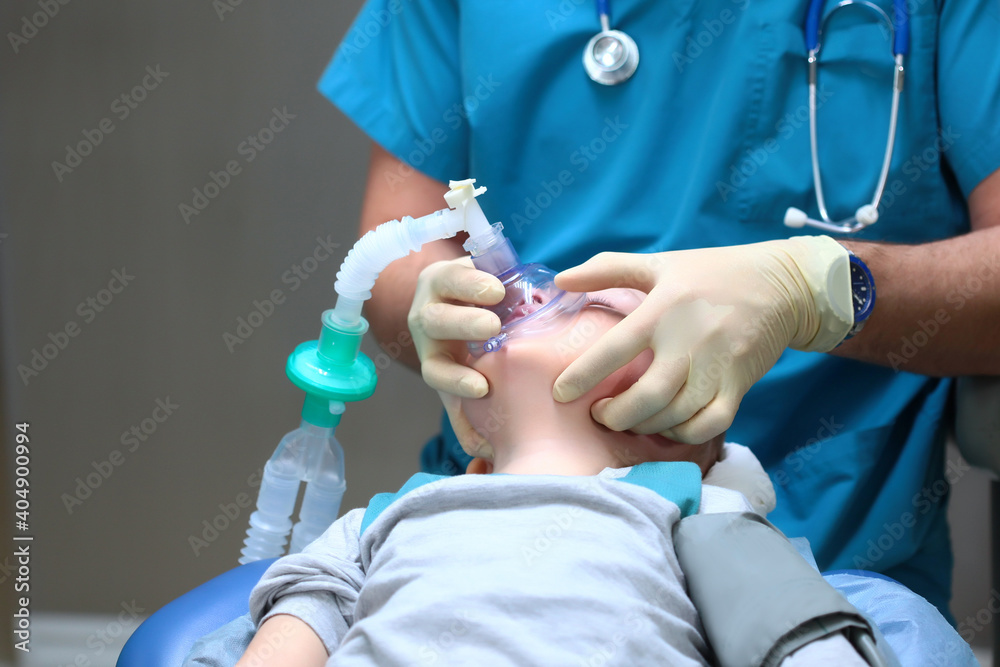 Preparing a young boy for dental surgery. General anesthesia. Treatment ...
