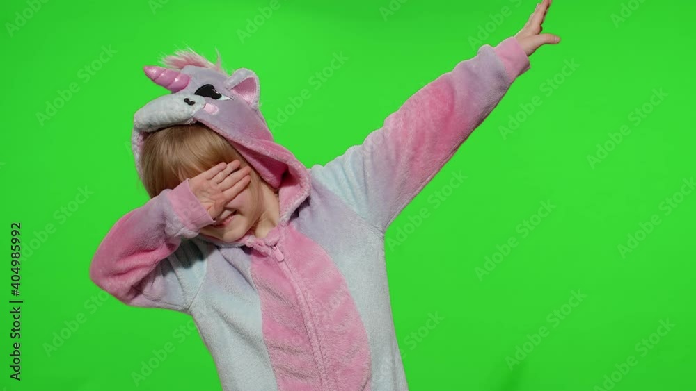 Child smiling, dancing, celebrating, performing dab dance in unicorn ...
