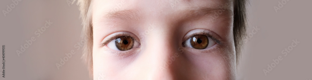 boy, kid, part of the face, funny eyes close up, looking directly, the ...